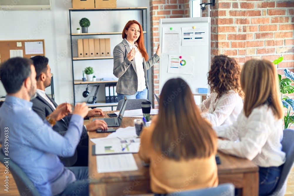 Group of business workers working together in a meeting. One of them ...