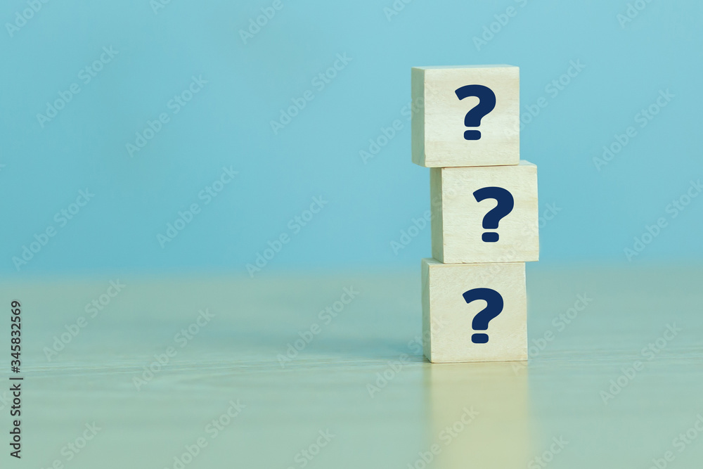 Group of wooden block with sign question mark symbol on the table over ...