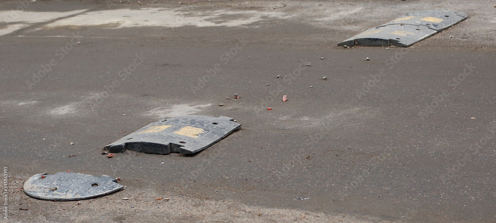 Broken speed bump on the road Stock Photo | Adobe Stock