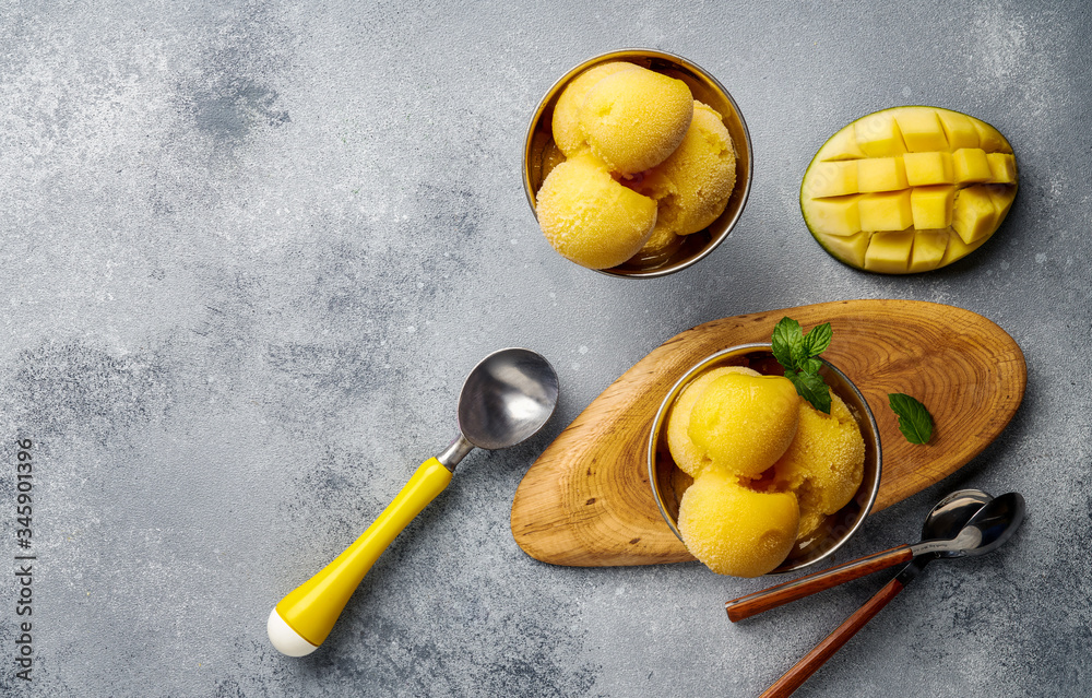 Mango ice cream on gray concrete background. Copy space. Top view of ...