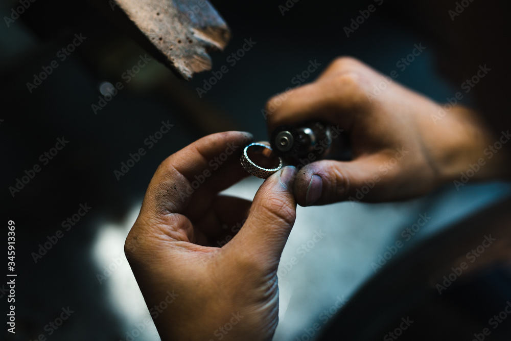 Master of jewelry while working on making a gold ring. Top view. Stock ...