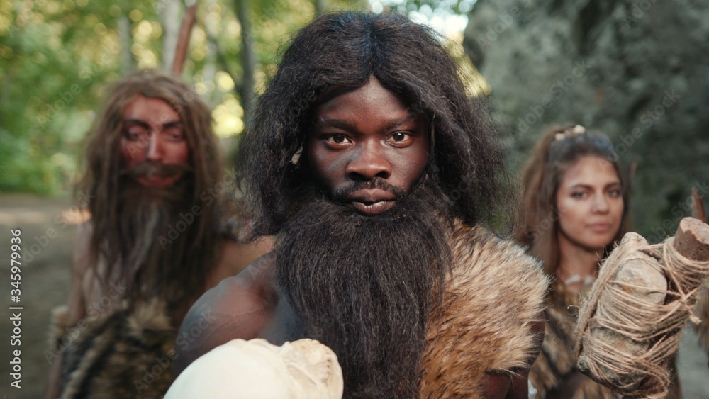 Savage tribe of primitive hunter-gatherers showing human skull at ...