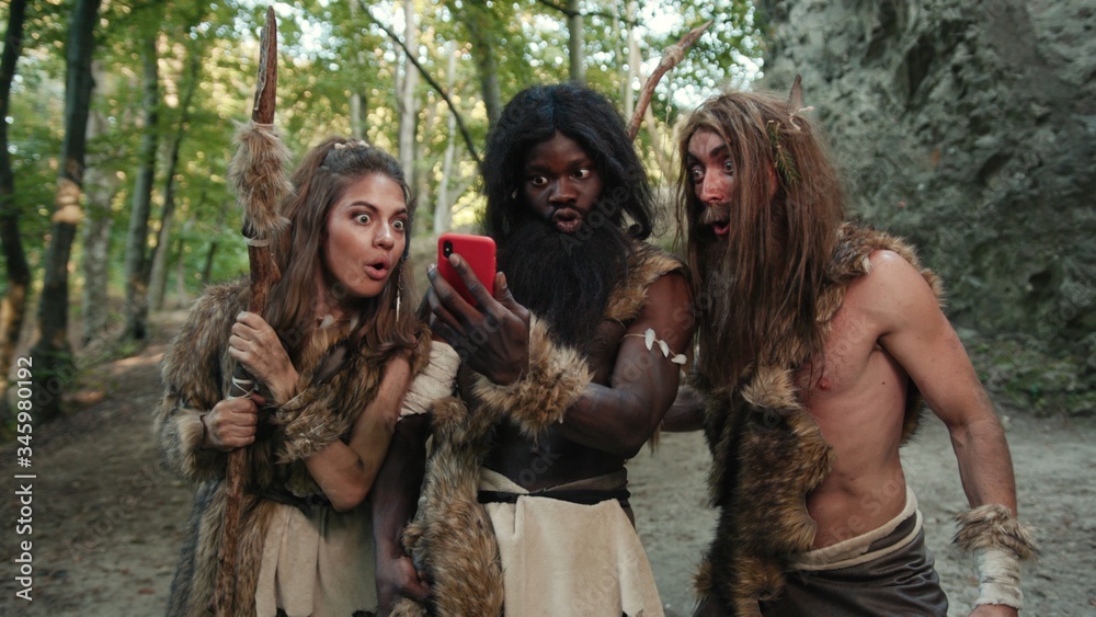 Fotka „Ancient neanderthals tribe people hunting in forest looking at ...