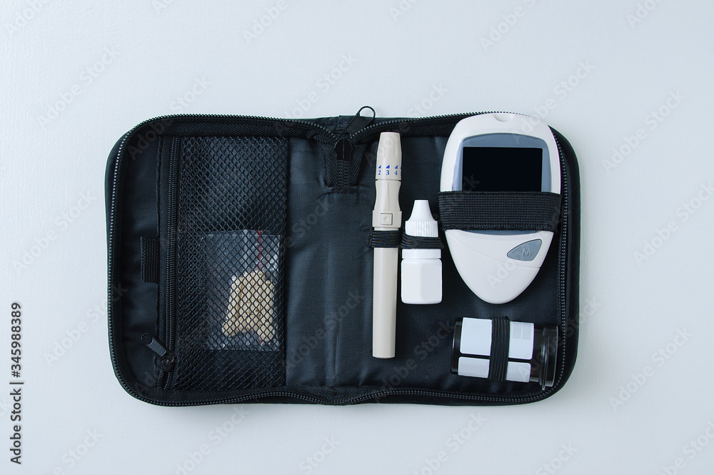 Set for measuring blood sugar in a black case. Electronic glucometer ...