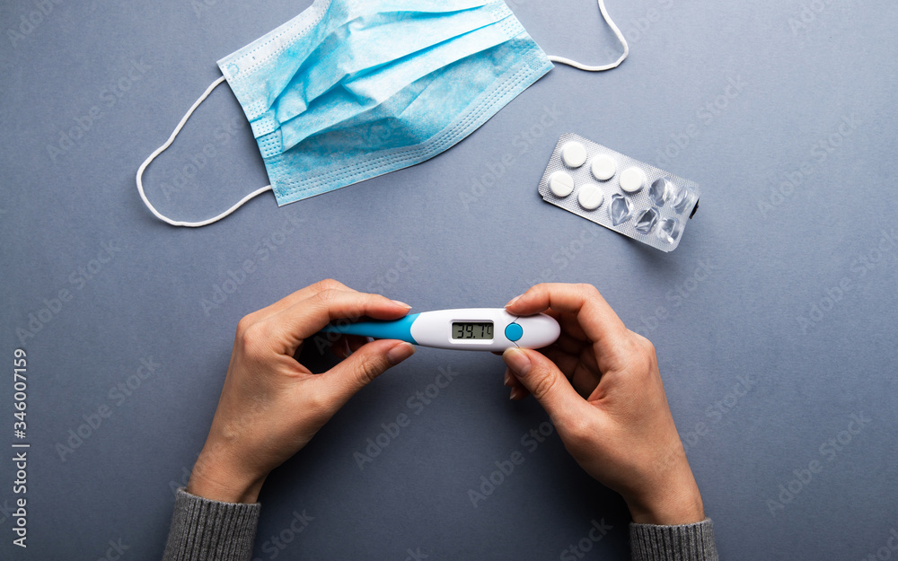 Measuring body temperature with a thermometer. Concept with sick person ...
