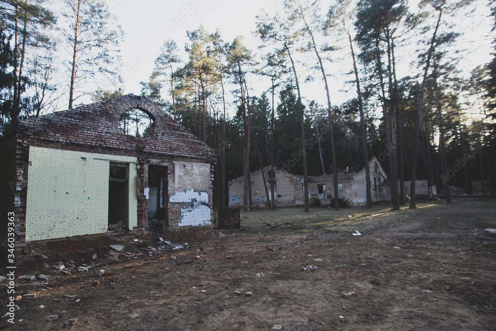 Old abandoned Soviet age camp: ruined damaged buildings in the forest ...