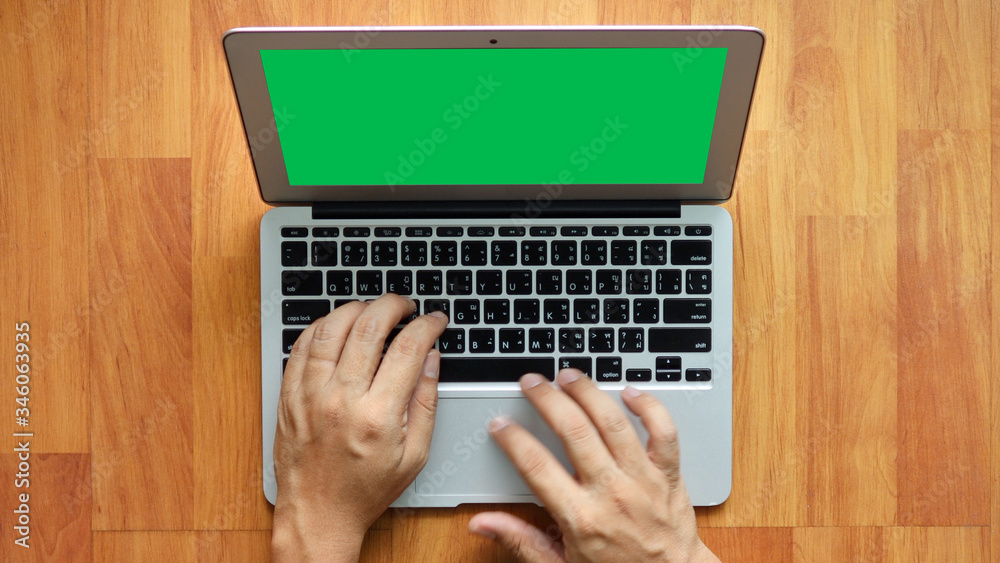 Man hands working on the laptop and touch pad, isolated on green screen ...