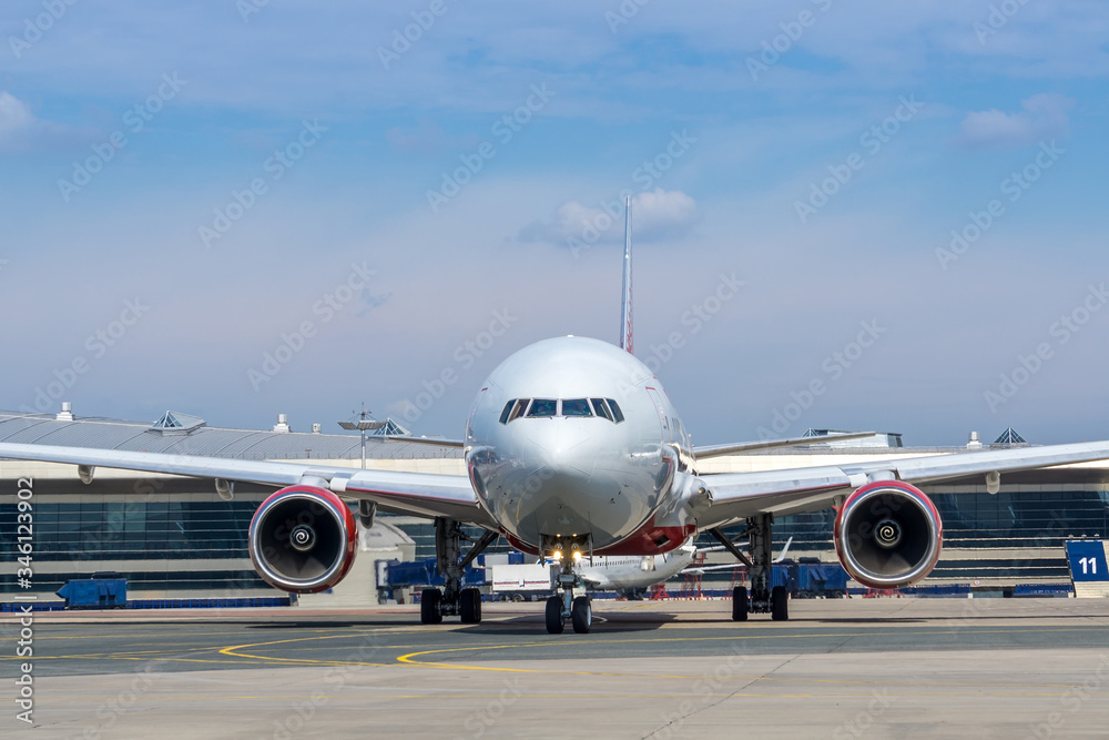 The front view of the huge passenger plane on front of the airport ...