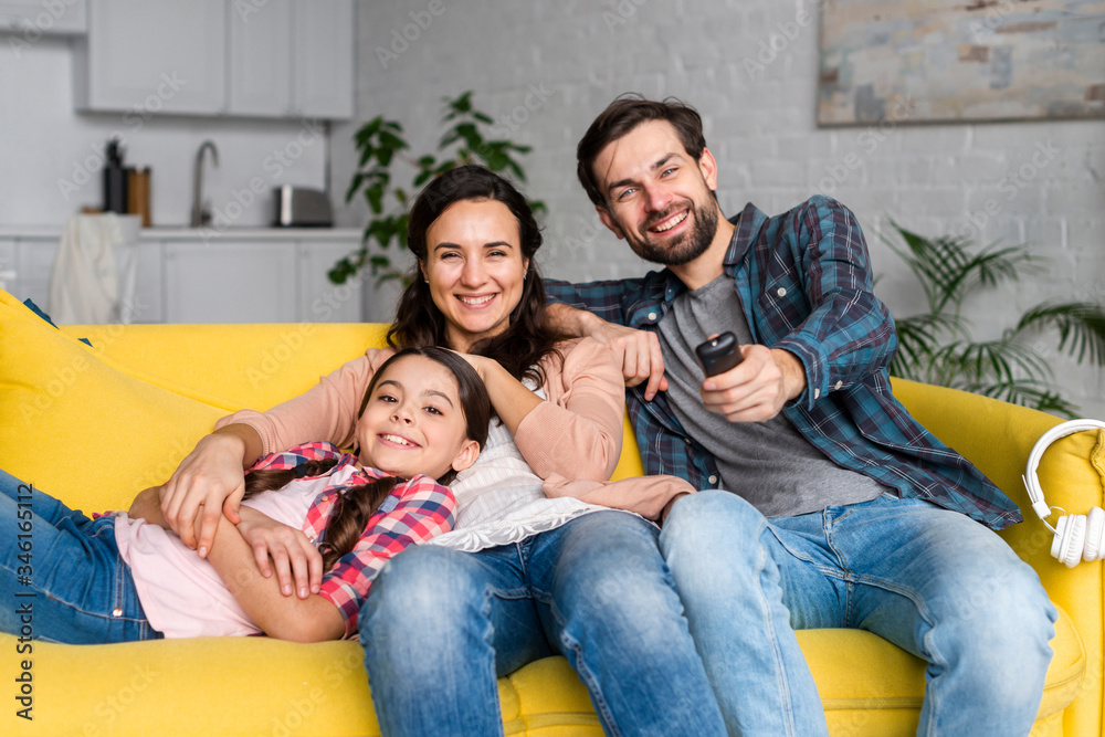 Happy family watching tv front view on sofa. Home leisure lifestyle ...