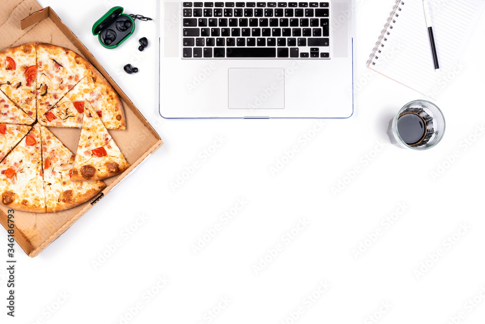Pizza in a cardboard box and laptop on a white background. Copy space ...