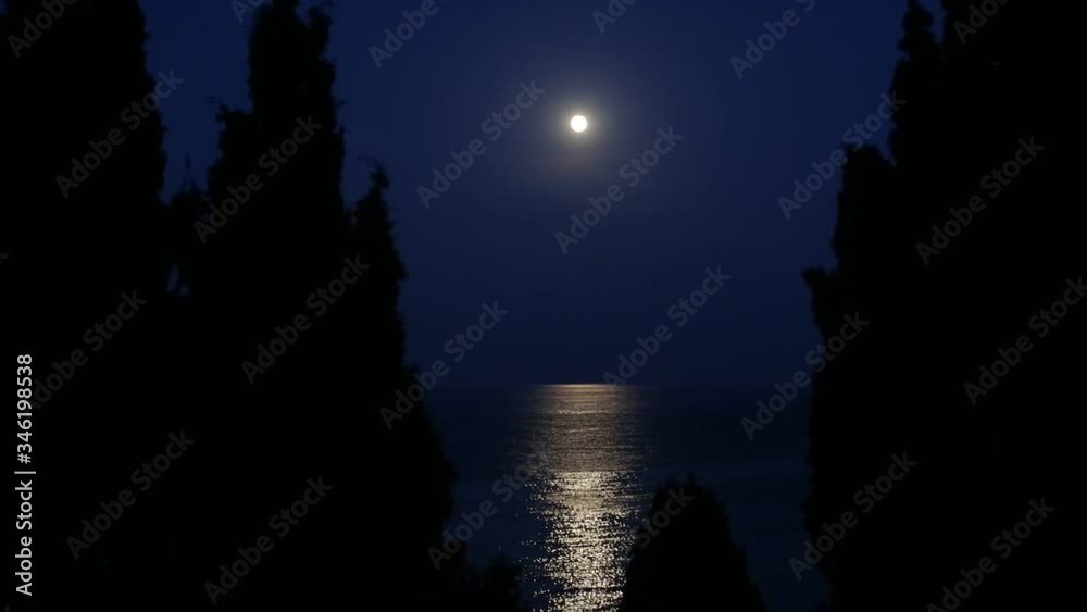 Beautiful full moon on a cloudless sky above the sea with a inspiring ...