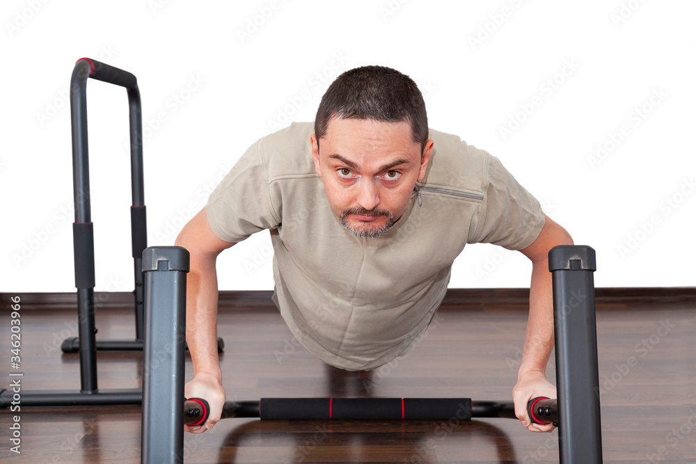 Home workout. Normal guy doing biceps and triceps training in the ...