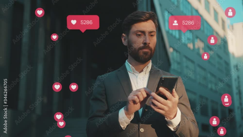 Wonder handsome young man uses smartphone typing social media icons ...