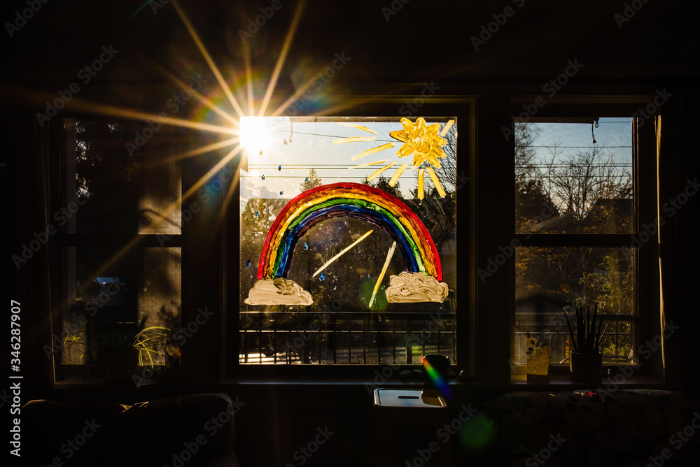 Rainbow with sun and clouds on window for encouragement during pandemic ...