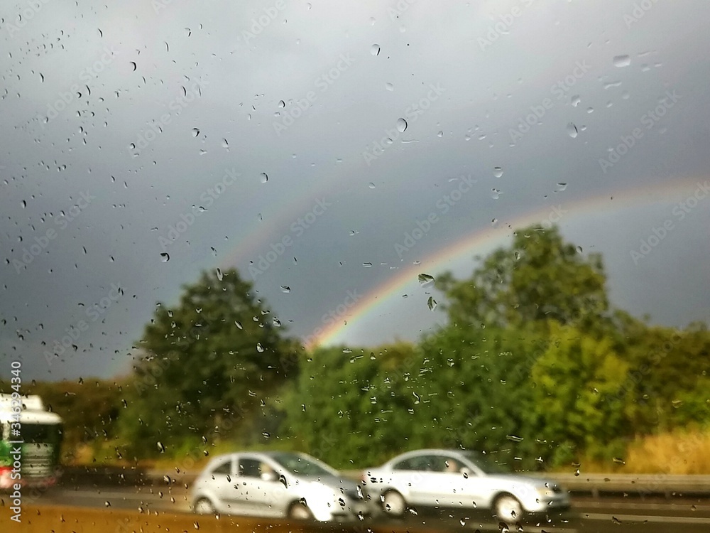 Rainbow Over Cars On Road Seen Through Glass Window During Monsoon ...