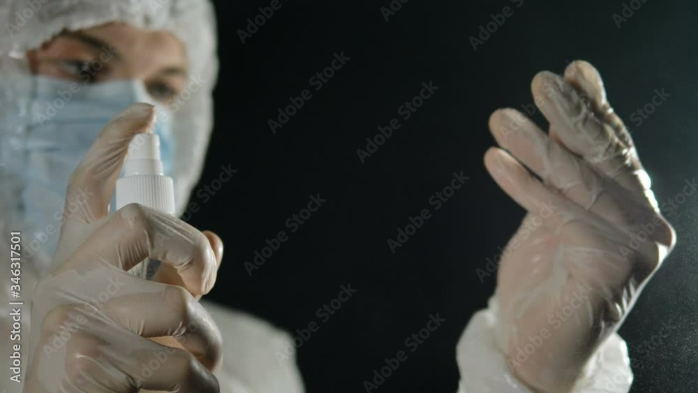 man presses a spray splash on a black background, a doctor in a white ...