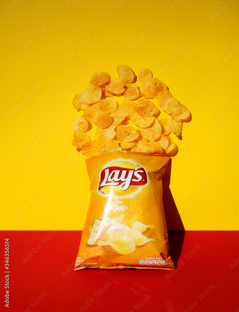 Kiev, Ukraine - May 8, 2020: open packet of Lays chips on a red-yellow ...