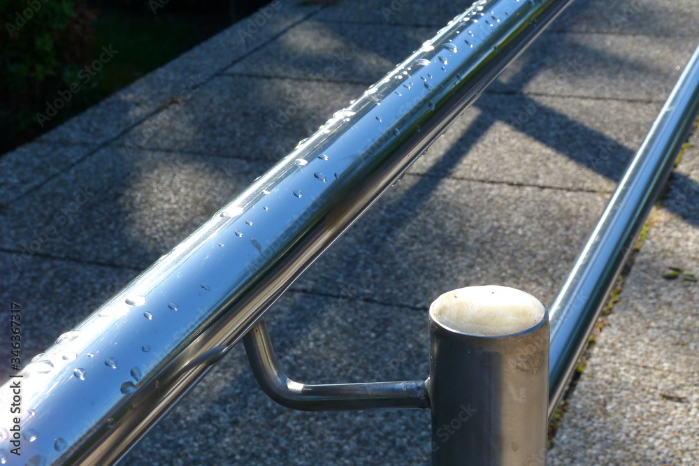 shiny stainless steel guard and handrail. selective focus. blurred gray ...