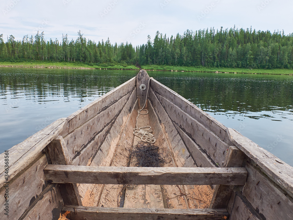 Old and wooden boat front and green forest landscape, sailing in the ...