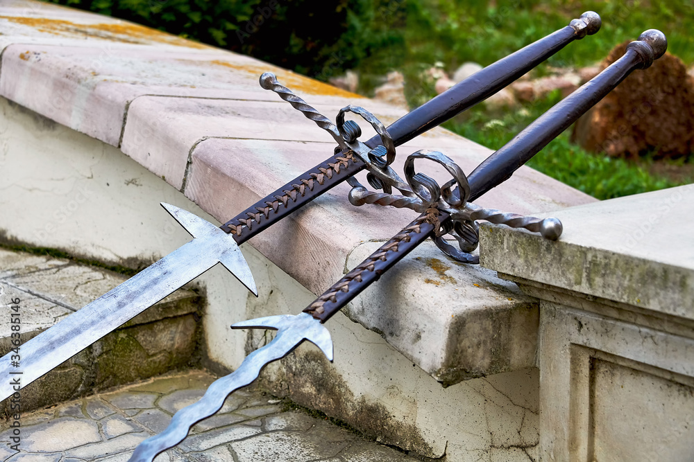 Two large antique two-handed swords. The sword is a weapon of medieval ...