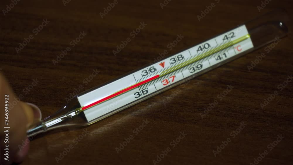 Glass thermometer on woman hands using animation shows rising ...