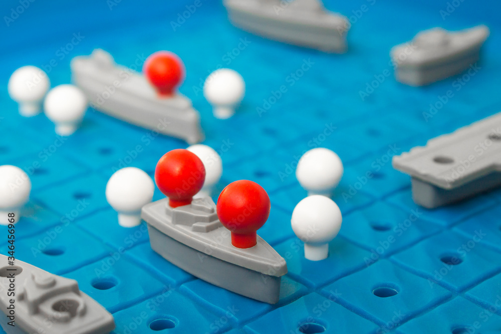 Battleship, board game. Sea battle. Toy ships on a plastic board ...