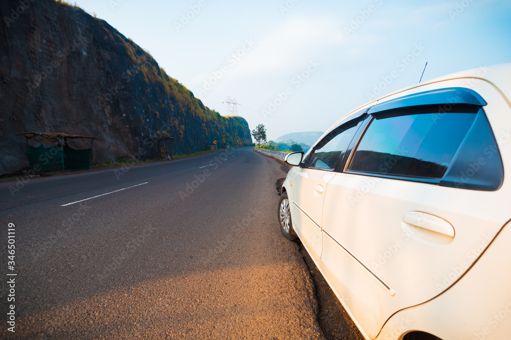 Scenic old Mumbai Pune expressway, empty road, white car parked by the ...