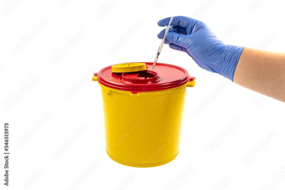A person throwing away a syringe into a medical waste container. Stock ...