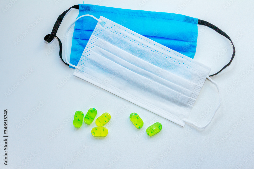 Blue and white medical masks and lozenges for cough and sore throat ...