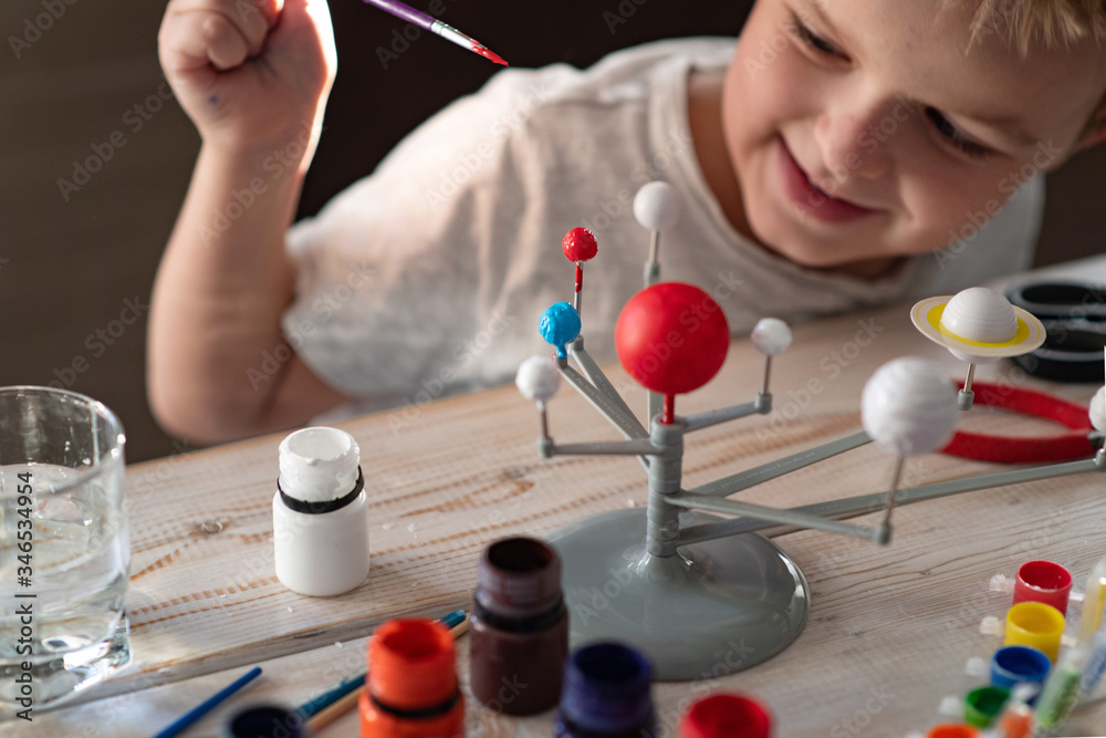 Foto de Boy tinkering a model of the solar system Concept of teaching ...