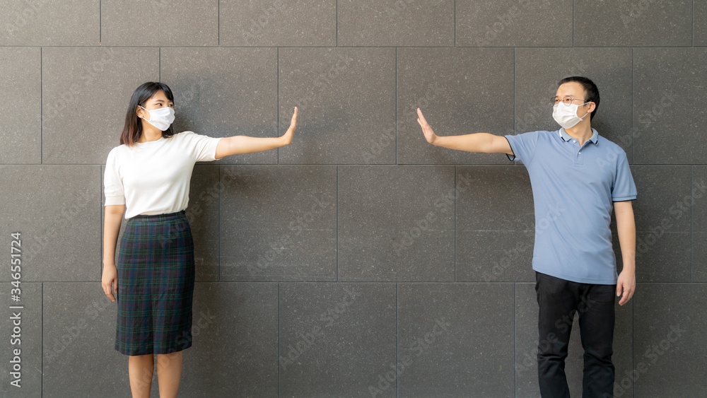 Young Asian couple wearing face masks meeting and standing against the ...