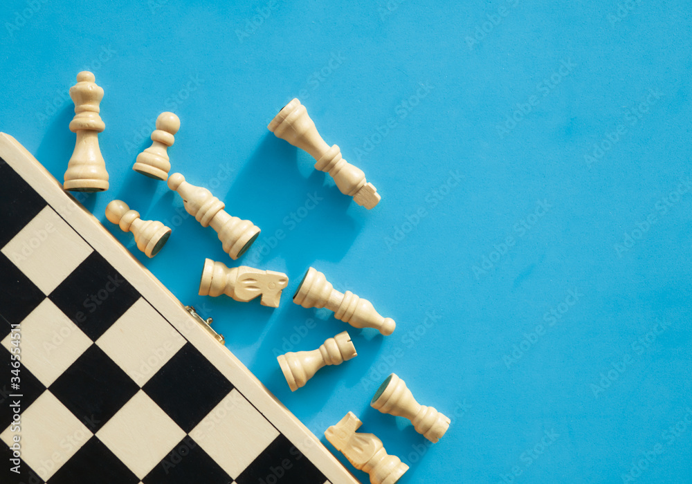 White chess pieces lying next to a chessboard, top view. Stock Photo ...