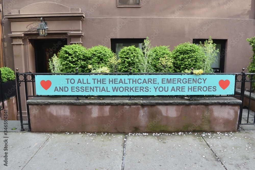 Sign on a fence railing reading To All The Healthcare, Emergency And ...