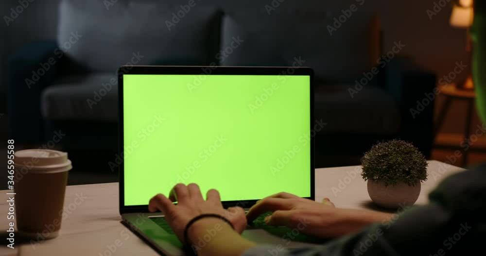 Close up shot of distant worker typing on keyboard of laptop computer ...