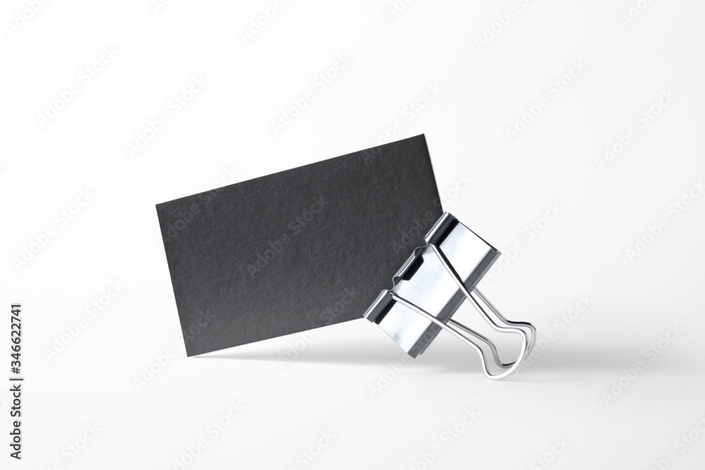 Blank black letterpress business cards stack in the clamp isolated on ...