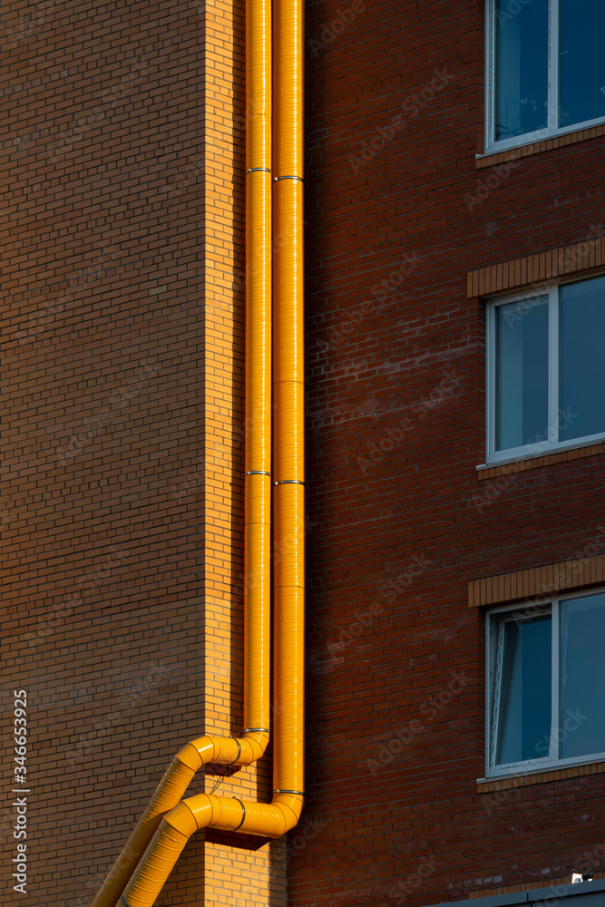ventilation pipes on a brick building, an element of a high-rise ...
