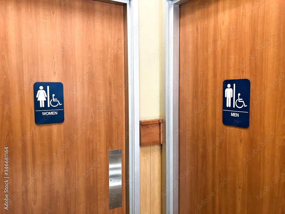 Two Public restroom doors with blue signs specifying male and female ...