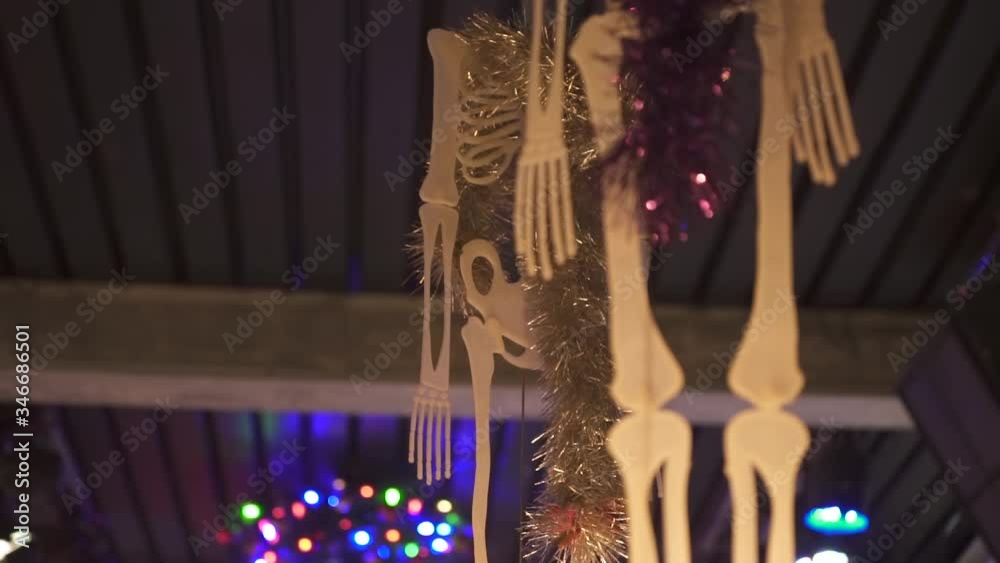 Plastic glossy layout of the human skeletons. Skeleton swinging on dark ...