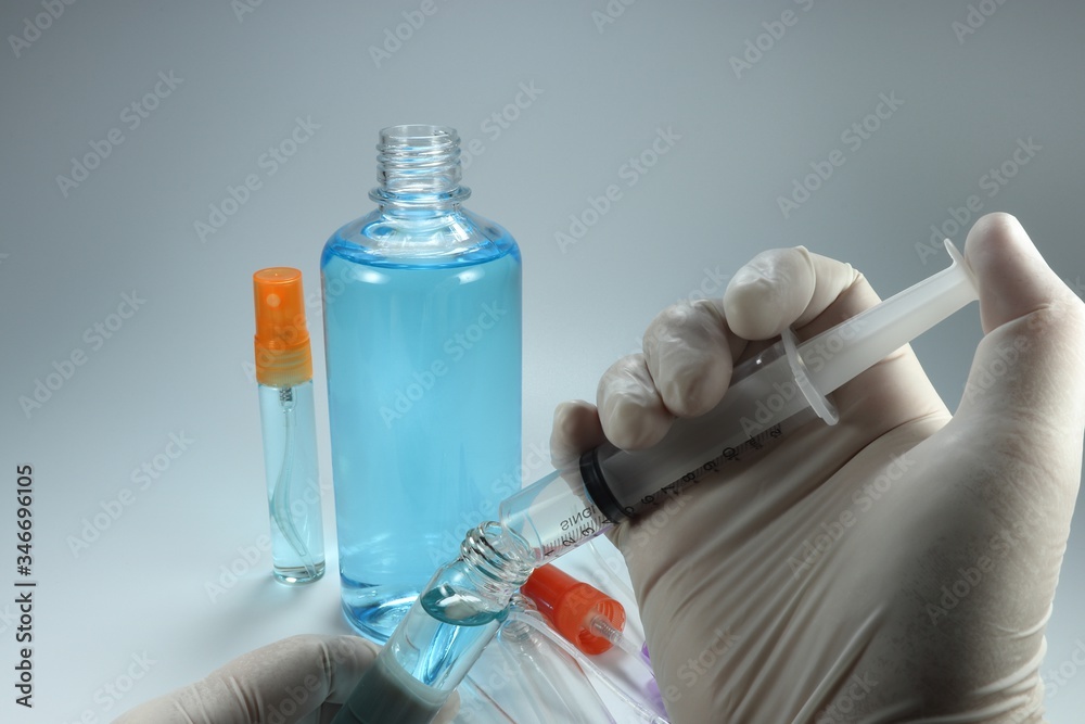 Local medical staff filling alcohol in glass bottle spray mist cap by ...