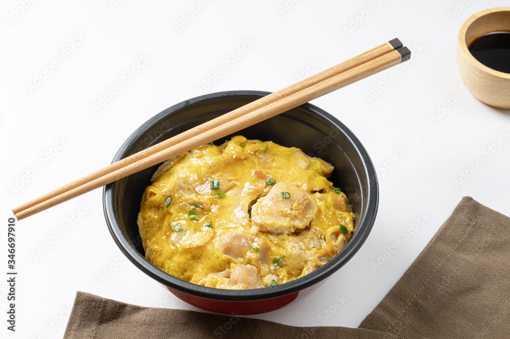 Oyako-don rice bowl topped with chicken, onions and egg cooked with ...