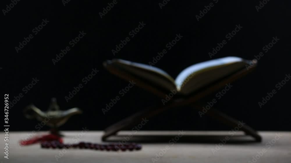 Quran in the mosque - open for prayers The black background of the ...