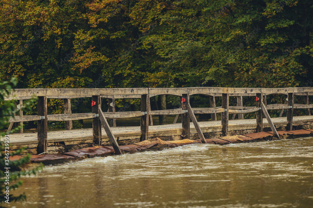 Flooded wooden trestle bridge with road, due to heavy rain and bad ...