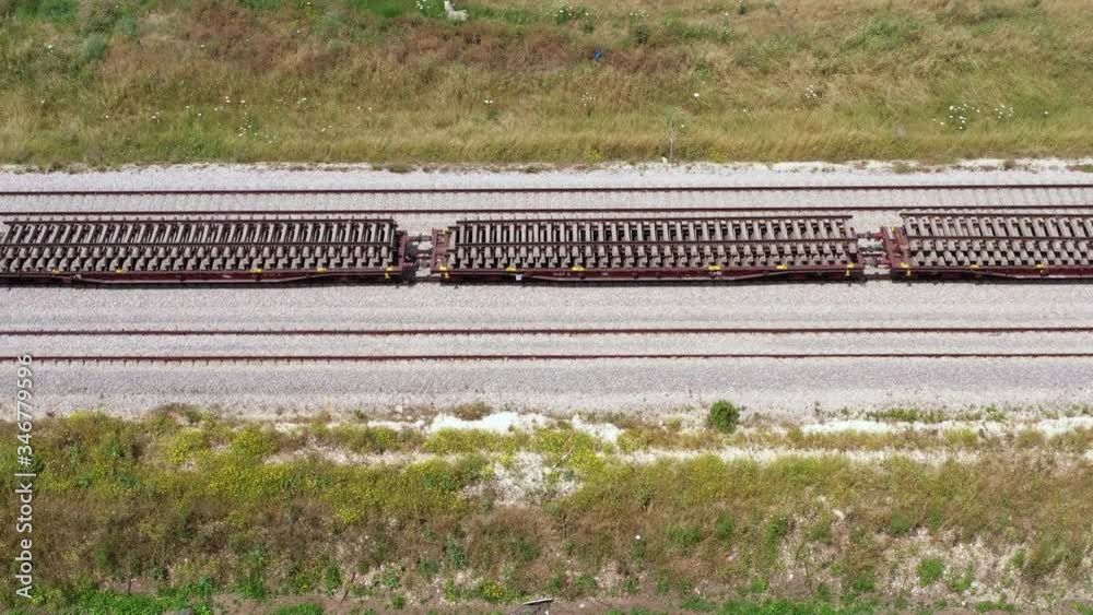 Train loaded with new Railroad tracks at full stop during a large scale ...