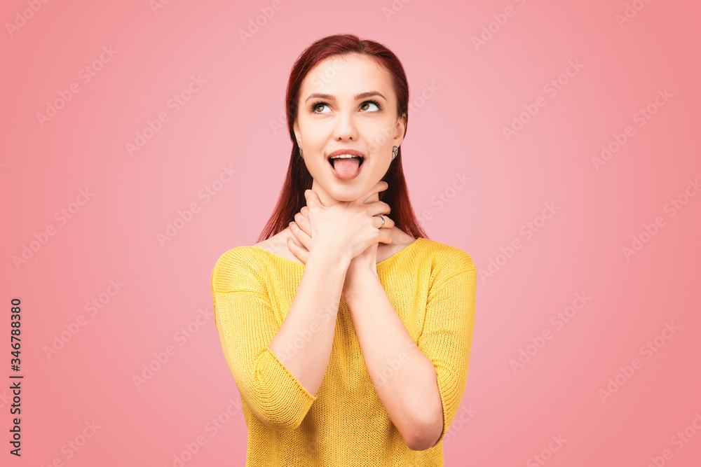 Funny girl makes faces hands behind neck, tongue sticking out, eyes ...