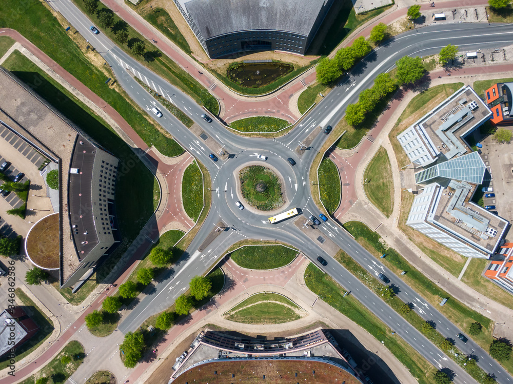 Top down aerial view of multi level turbo roundabout with road and ...