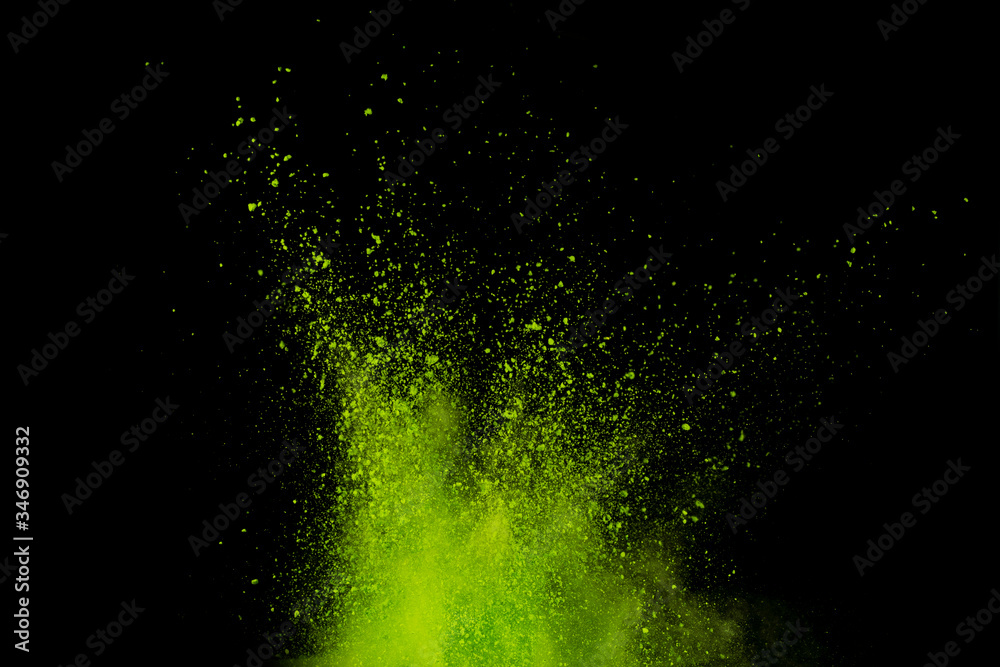 green powder explosion isolated on Black background.Colored dust splash ...