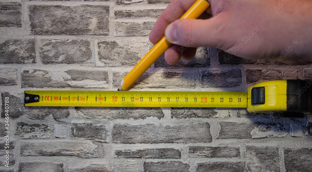 Measured with a tape measure and mark with a pencil on a brick wall ...