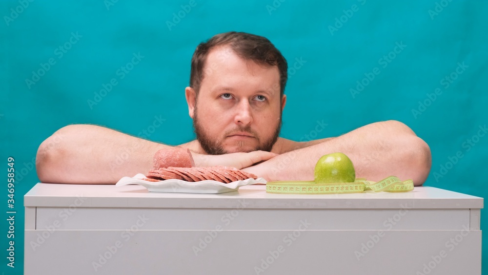 It is difficult to choose the concept of a healthy diet: a man choosing ...