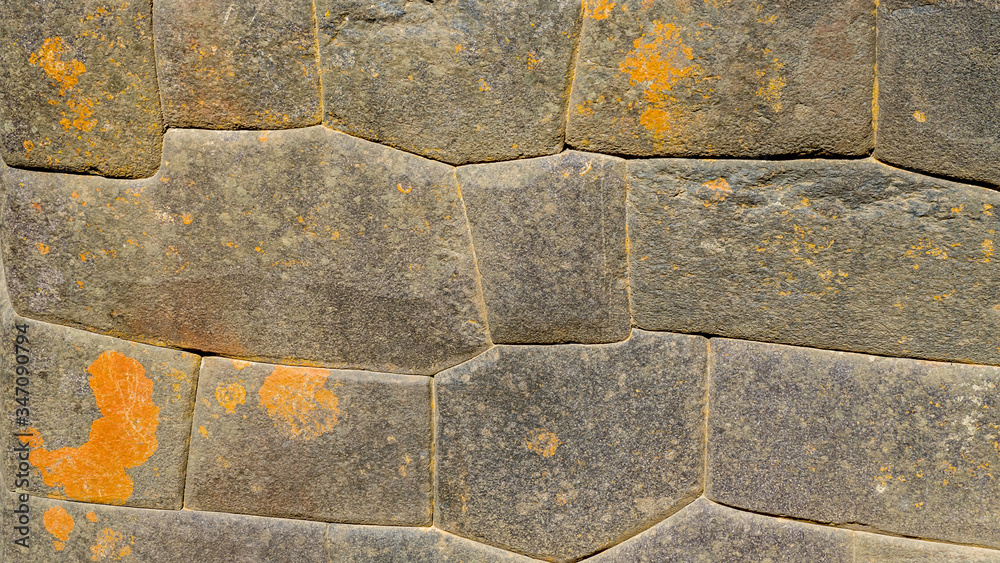 inca stone wall with perfect shaped granite and fitting stones, orange ...