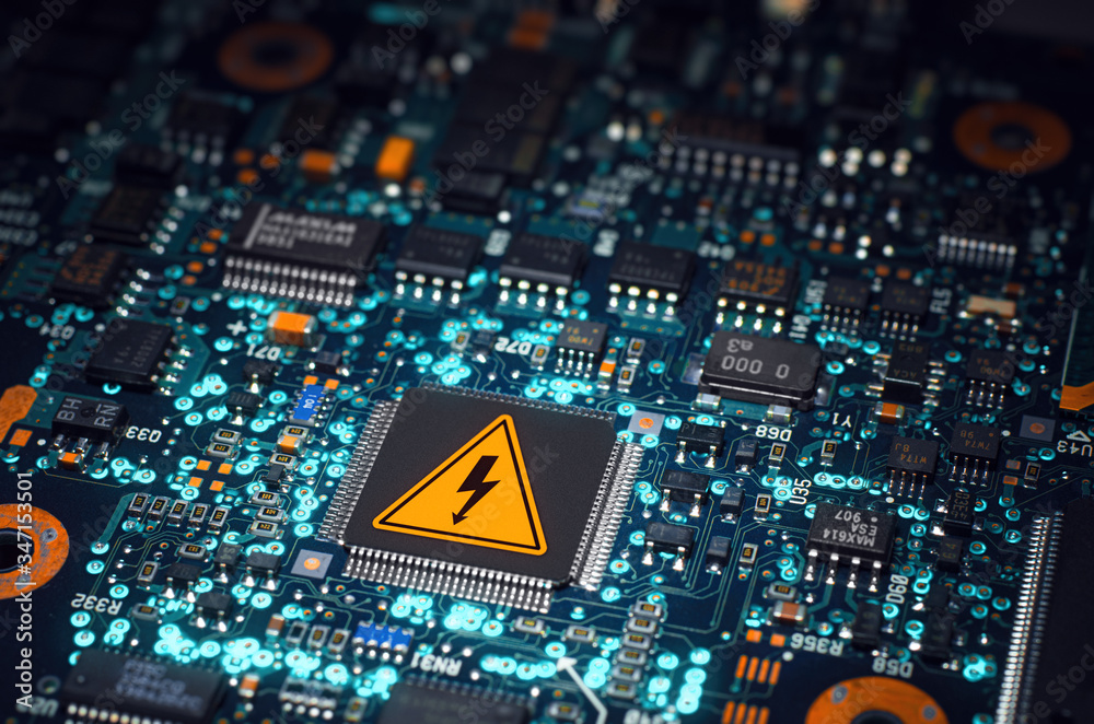 Square smd microchip with electrical warning sign mounted on blue pcb ...